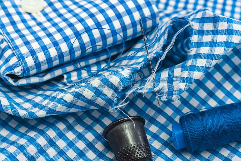 Needle and Thread on a Checkered Fabric Close-up. Seamstress or Tailor ...