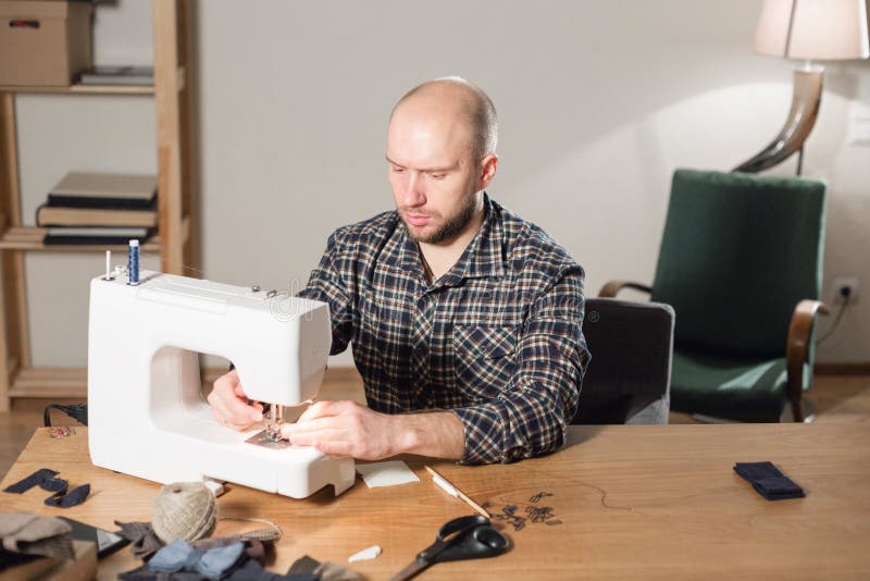 With a Needle and Thread in Hand. Good Looking Young Man Working As a ...