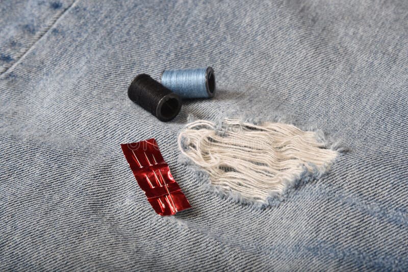 Needle and thread on jeans stock photo. Image of material - 161126980