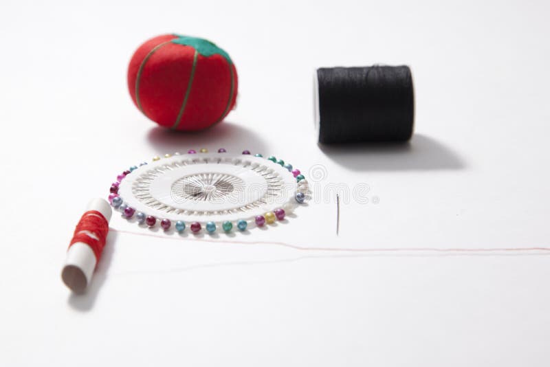 Needle with Red Thread and Stitches in Shape of Heart on White Fabric ...