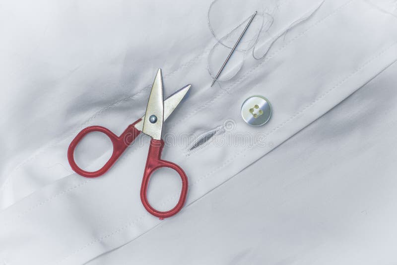 Needle Thread Scissors and Button Over White Shirt Stock Photo - Image ...