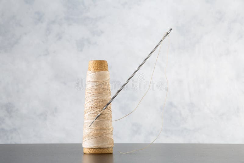 Needle and Thread on a Table Stock Image - Image of backdrop, spool ...