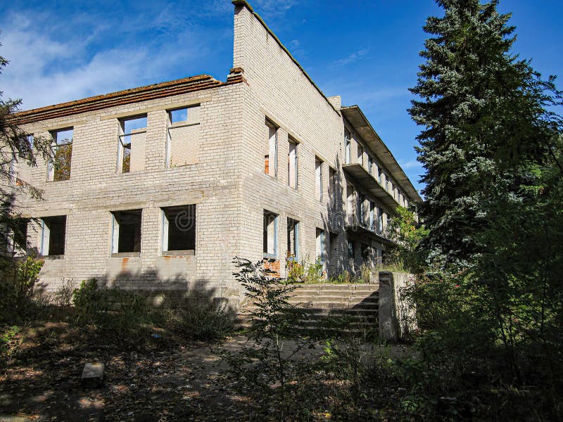 A Neglected Multi-story Brick Building with Exposed Bricks, Peeling ...