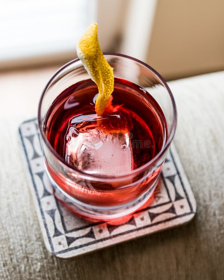Negroni Cocktail with Lemon Peel and Ice Stock Image - Image of dark ...