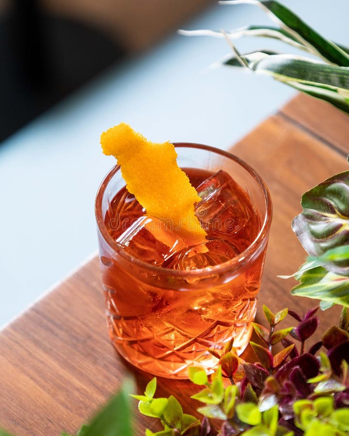 Negroni Cocktail Standing on Table with Orange Peel Garnish Stock Photo ...