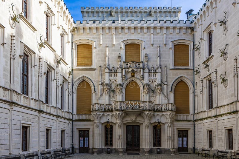 Neo-gothic Courtyard Facade with Arched Windows and Decorative Elements ...