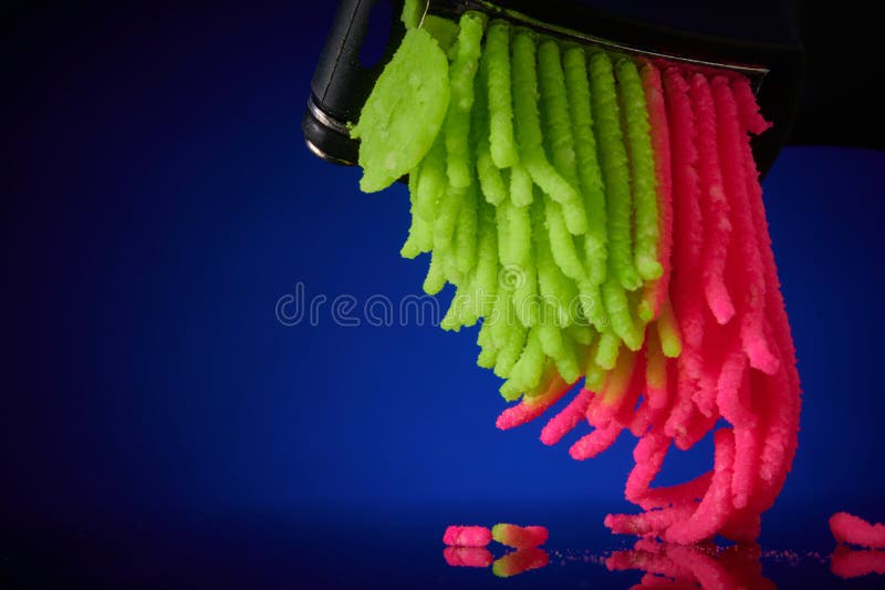Garlic Press Oozing with Color Stock Photo - Image of color, green ...