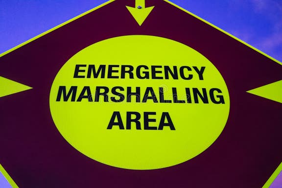 A Neon Emergency Marshalling Area Sign with Arrows Stock Image - Image ...
