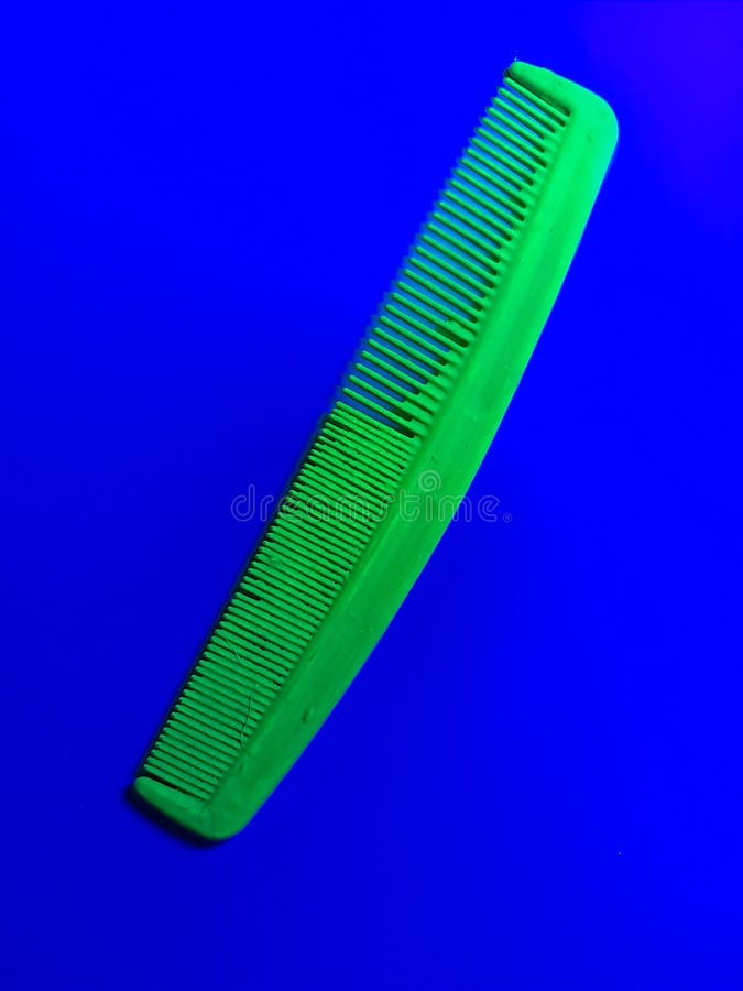Neon Green Comb Under a Black Light Glowing Stock Image - Image of ...