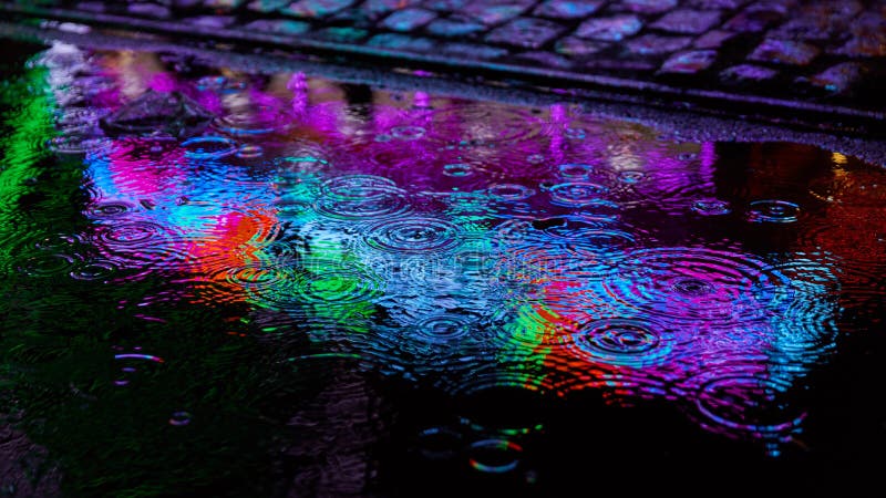 Neon Light As a Reflection in the Water of a Puddle when it Rains Stock ...