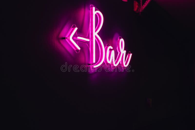 Pink Neon Bar Sign with Arrow at Night Stock Photo - Image of ...