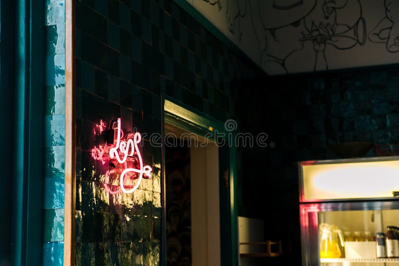 Less Neon Sign Mounted On Glass Board Near Open Window And Glass ...