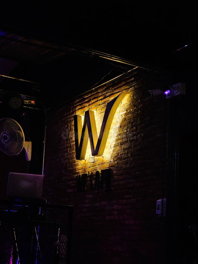 A Neon Sign in the Shape of a Capital Letter "W" Stock Image - Image of ...