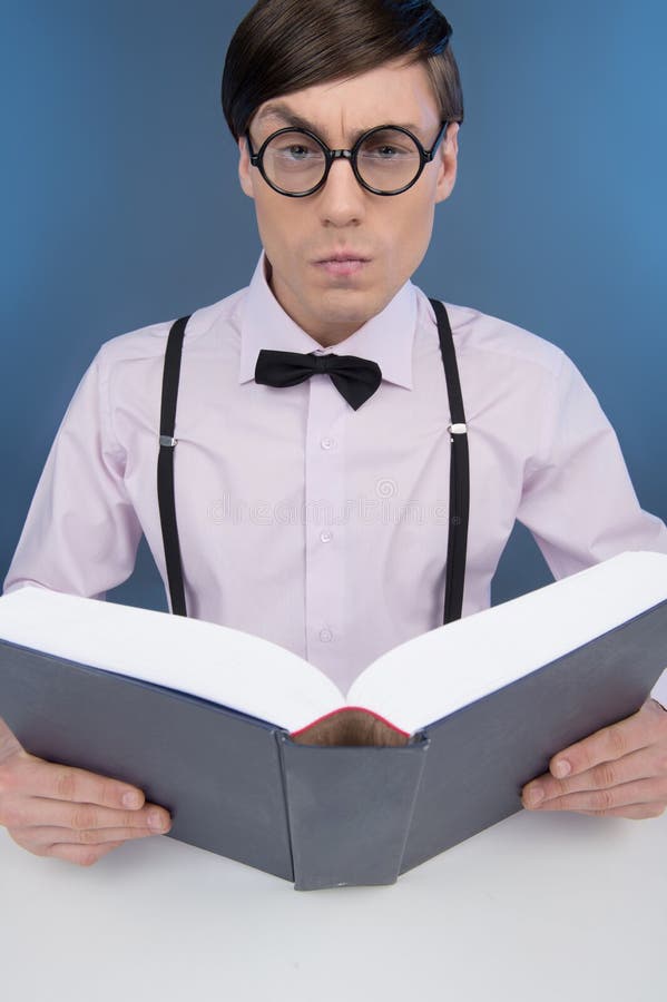 Nerd with book. stock image. Image of serious, holding - 33341715