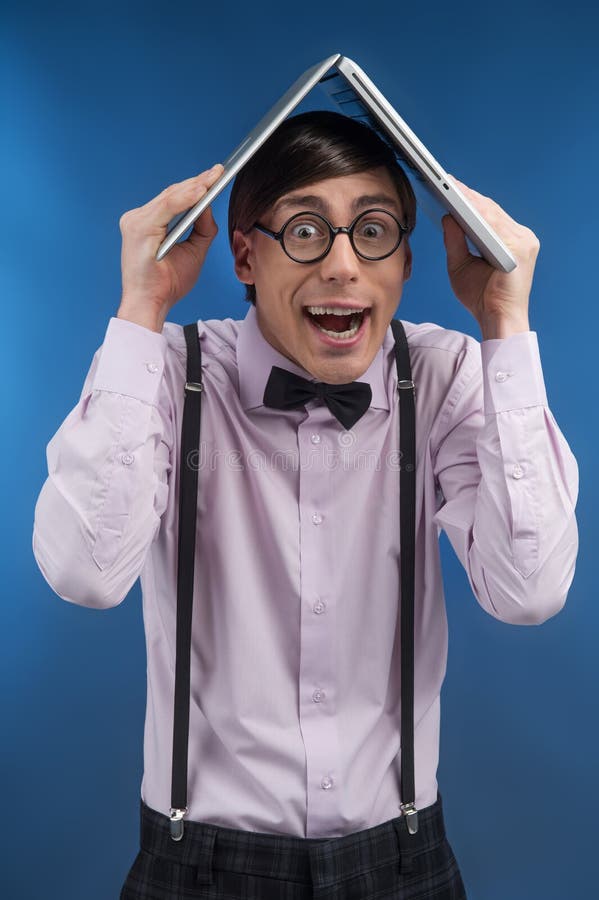 Nerd with Book. Young Nerd Man Holding a Book on Head while Stan Stock ...