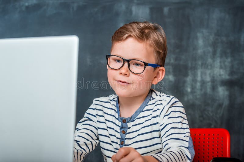 Child Using a Laptop Computer while Doing Homework Online on Laptop ...