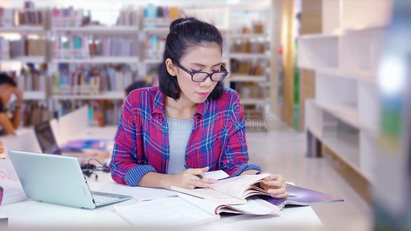 Nerd Student Learns and Read Books in Library Stock Footage - Video of ...