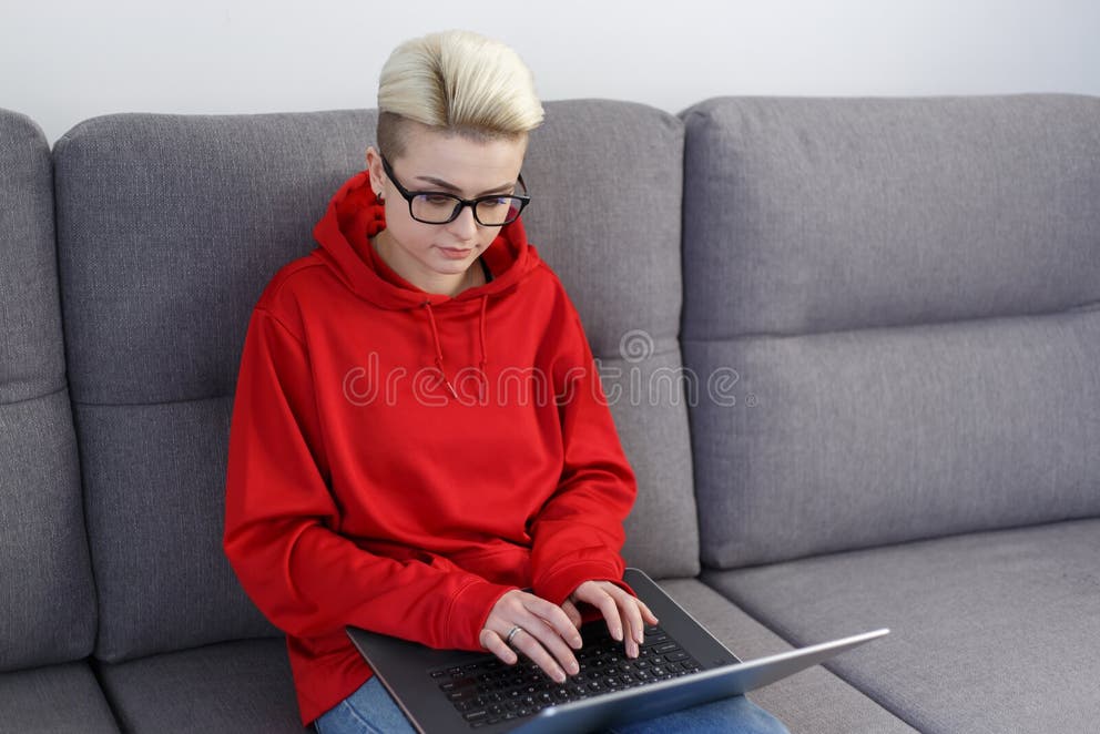 Young Adult Woman Working on Laptop Computer. Tom Boy Female with Short ...