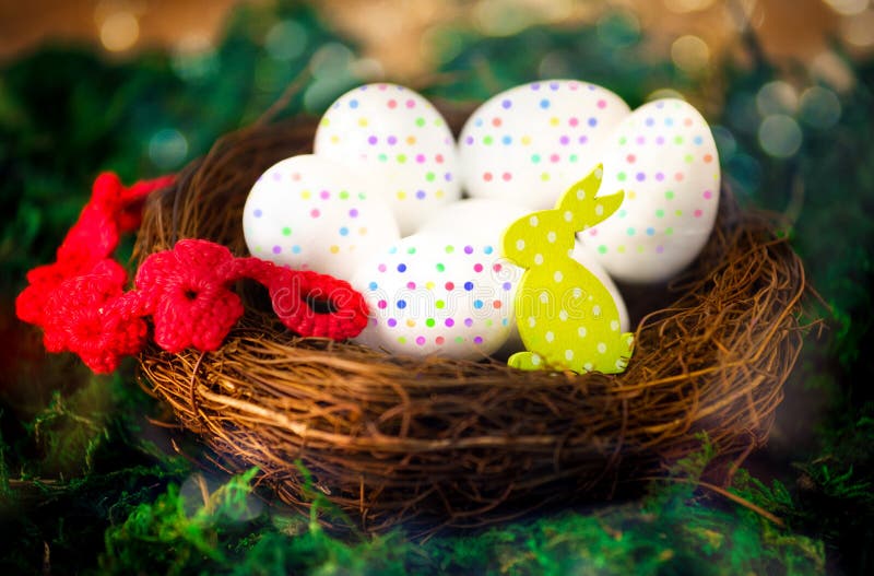 A Nest with Colourful Eggs and Yellow Rabbit on Green Moss for Easter ...