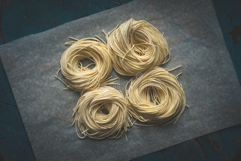 Nests of Fresh Spaghetti on the Paper Stock Image - Image of dinner ...