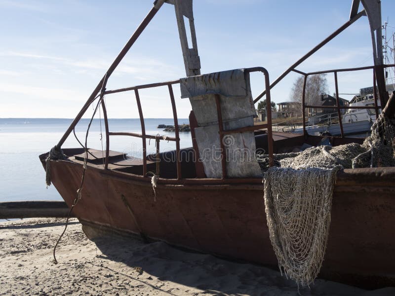 A Net on an Old Rusty Fishing Boat Pulled Onto a Sandy Riverbank Stock ...