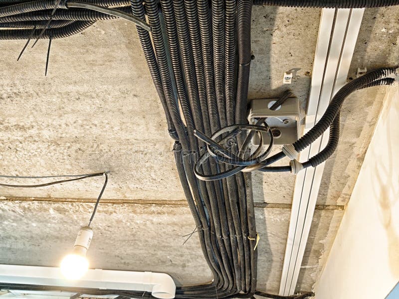 Network Cables and Electrical Conduits Run Along the Ceiling in a ...