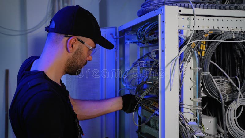 Network and Data Center with it Support Engineer Working in a Dark ...
