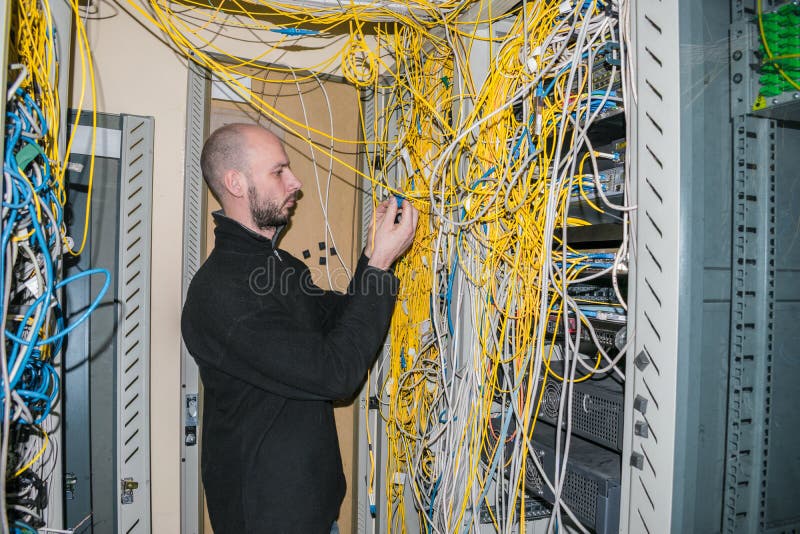 An Engineer Connects Magistral Optical Fiber Wires. a Man Commutes ...
