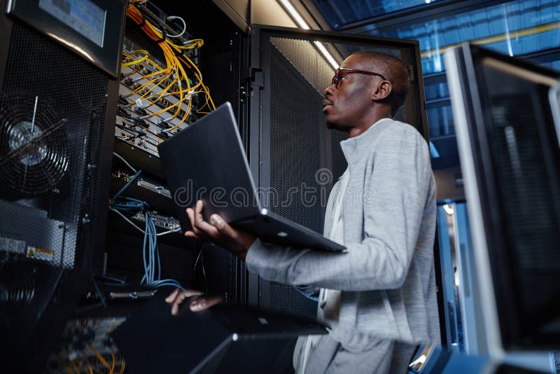 Network Engineer Using Laptop in Server Room Stock Photo - Image of ...