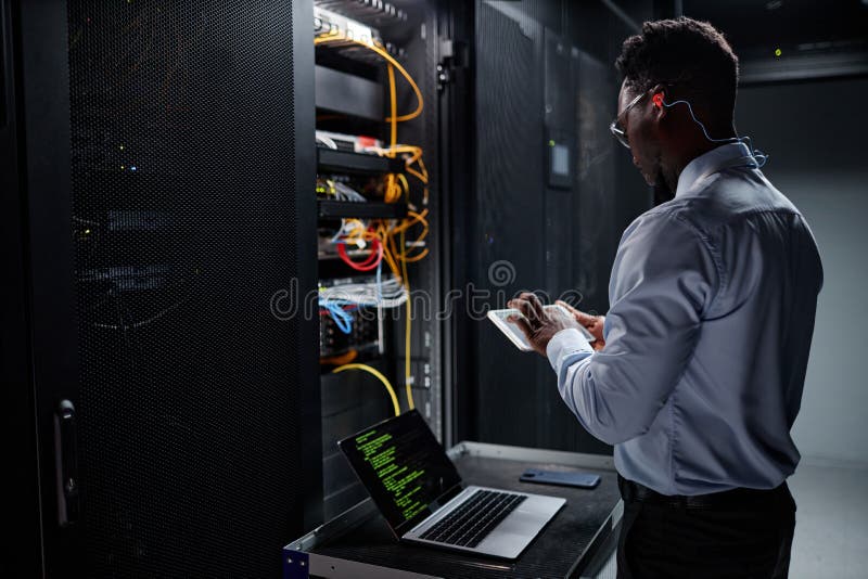 Network Engineer Using Laptop while Setting Up Servers in Data Center ... Network Engineer Using Laptop while Setting Up Servers in Data Center ...