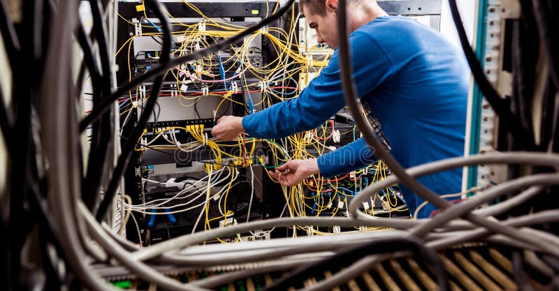 Network Engineer Working in Server Room. Connecting Network Cables To ... Network Engineer Working in Server Room. Connecting Network Cables To ...