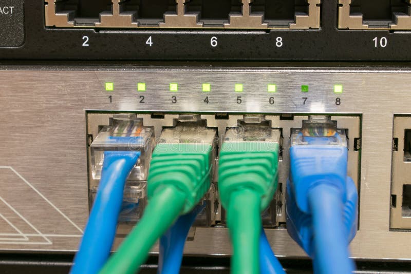 Network Switch with a Wire Connected To it. Green LED on the Front of ...