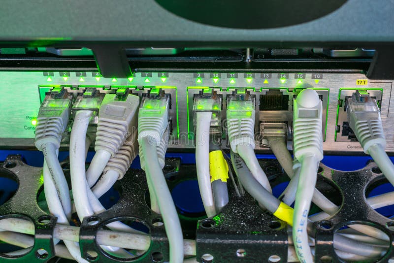 Network Switch with a Wire Connected To it. Green LED on the Front of ...