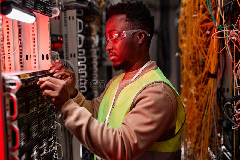 Network Technician Inspecting Servers in Data Center Red Neon Light ...