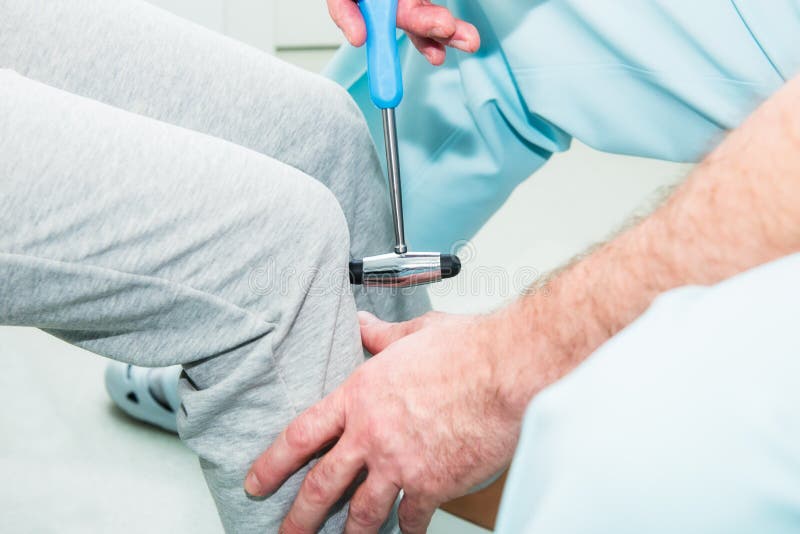 The Neurologist Testing Knee Reflex on a Female Patient Using a Hammer ...