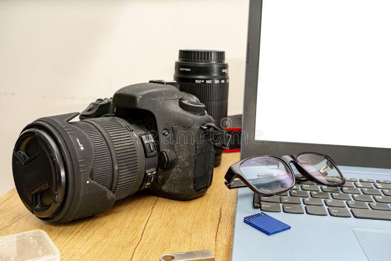 Neutral View of an Open Laptop with a Reflex Camera and a Pair of ...