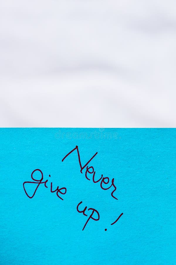 Never Give Up Handwriting Text Close Up Isolated on Blue Paper with ...