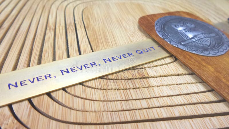 Never Quit Sign and Owl Tin Sign on Wooden Background Stock Image ...