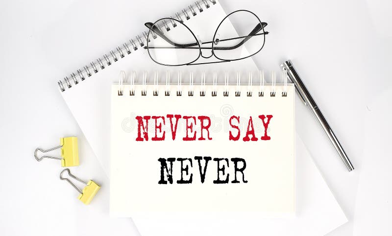 NEVER SAY NEVER Text on the Notebook with Pen,clips and Glasses Stock ...