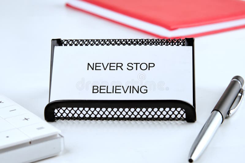 NEVER STOP BELIEVING Motivational Phrase on a White Business Card ...