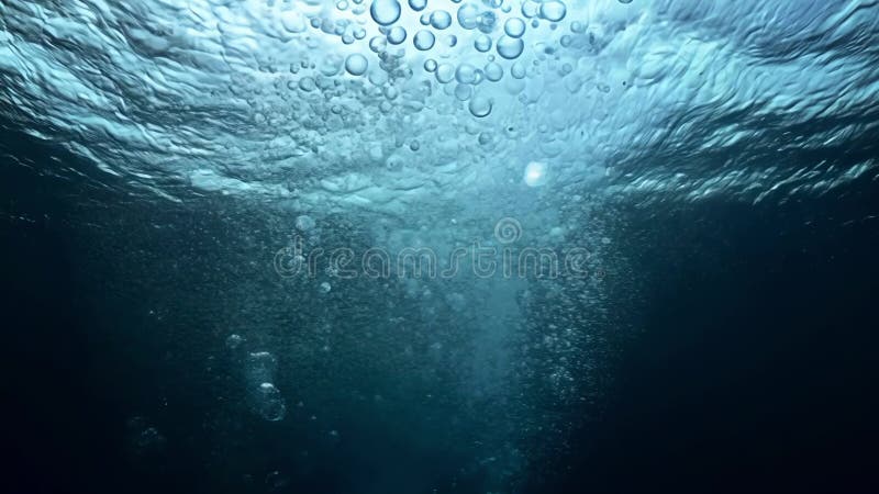 A Neverending Stream of Tiny Foam Bubbles Rising Up from a Deep Dark ...