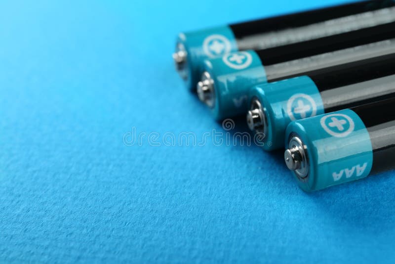 New AAA Batteries on Tuquoise Background, Closeup. Space for Text Stock ...