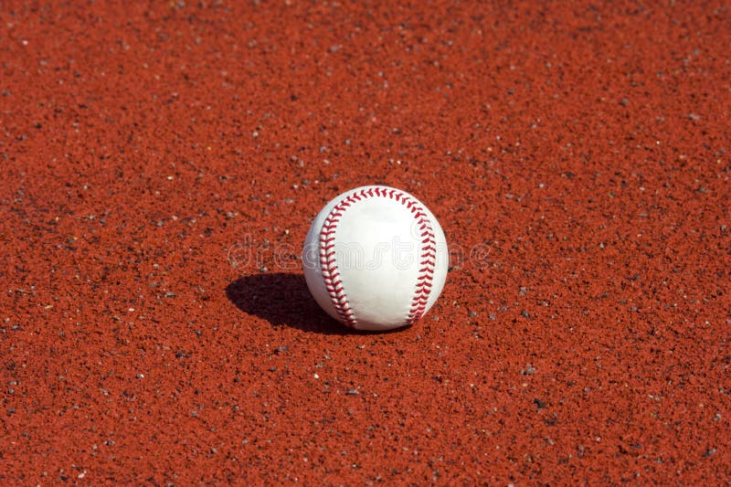 New Baseball Ball on Red Track Rubber Stock Photo - Image of baseball ...