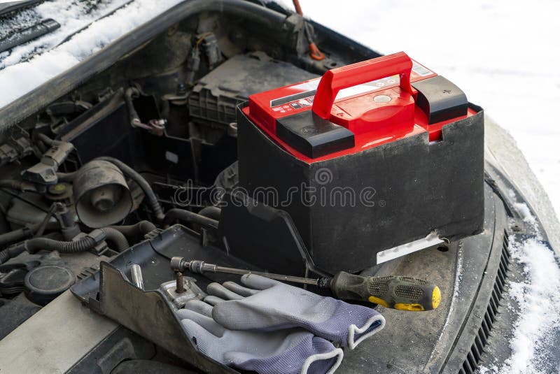A New Battery in the Engine Compartment of the Car in Winter. Stock ...