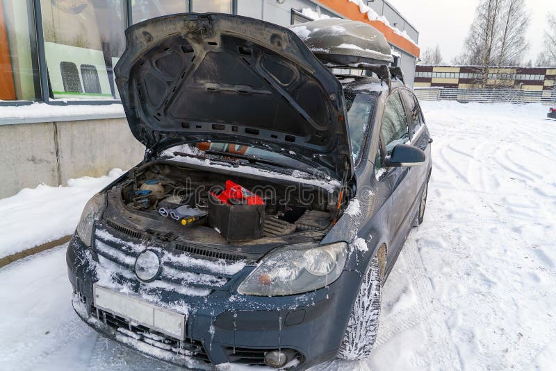 A New Battery in the Engine Compartment of the Car in Winter. Stock ...