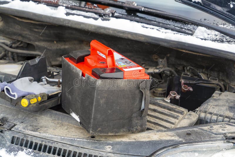 A New Battery in the Engine Compartment of the Car in Winter. Stock ...