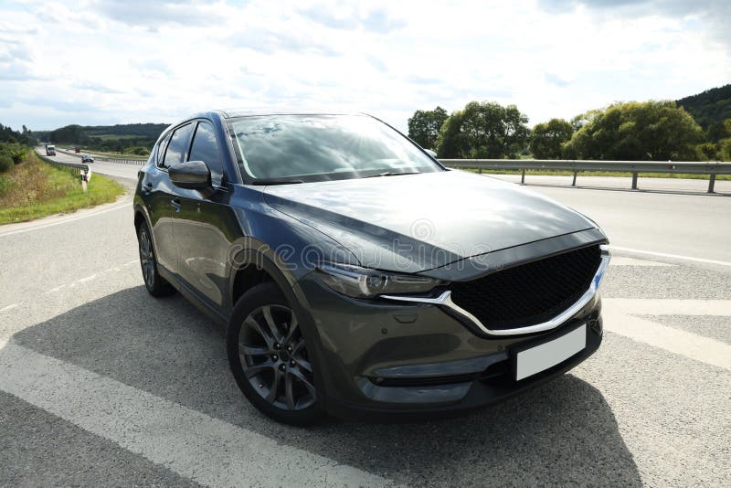 New Black Modern Car on Asphalt Road Stock Photo - Image of cloudy ...