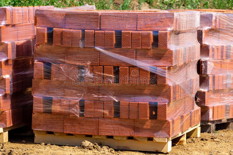 New Bricks Packed in a Pallet Standing on a Clay Surface of a ...
