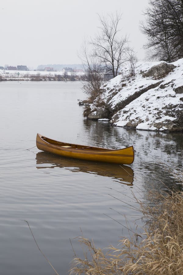 New Canoe Floating on the Calm Water in Winter Sunset Stock Photo ...