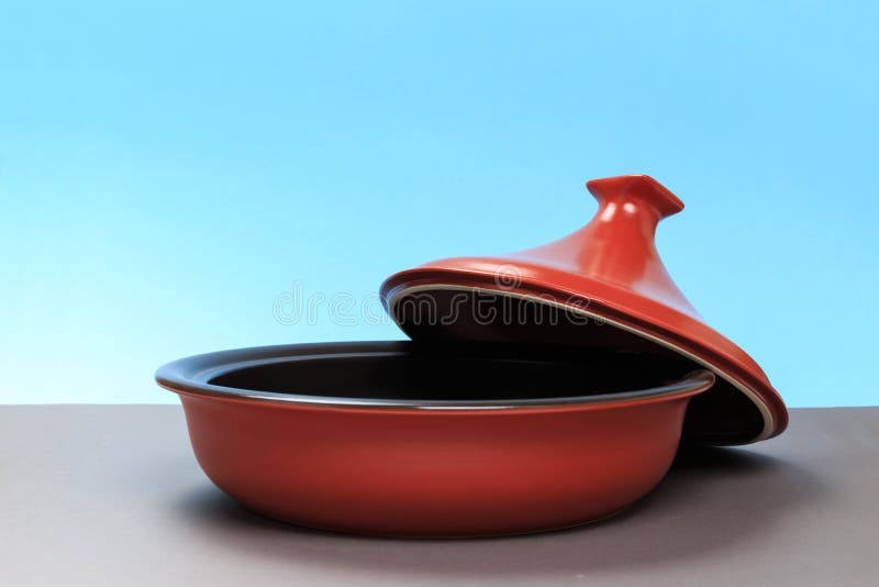 A New Ceramic Pan Stands on a Gray Table and a Blue Background. Close ...